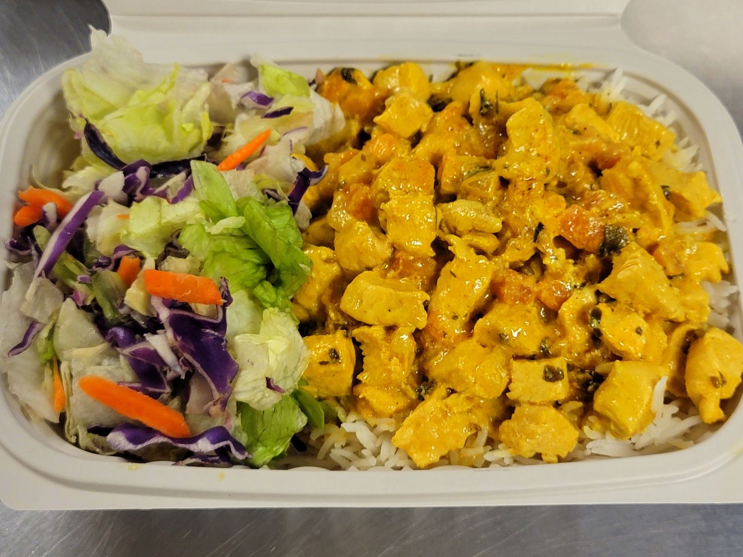 Nina's Desi Kitchen - Chicken Handi over Rice