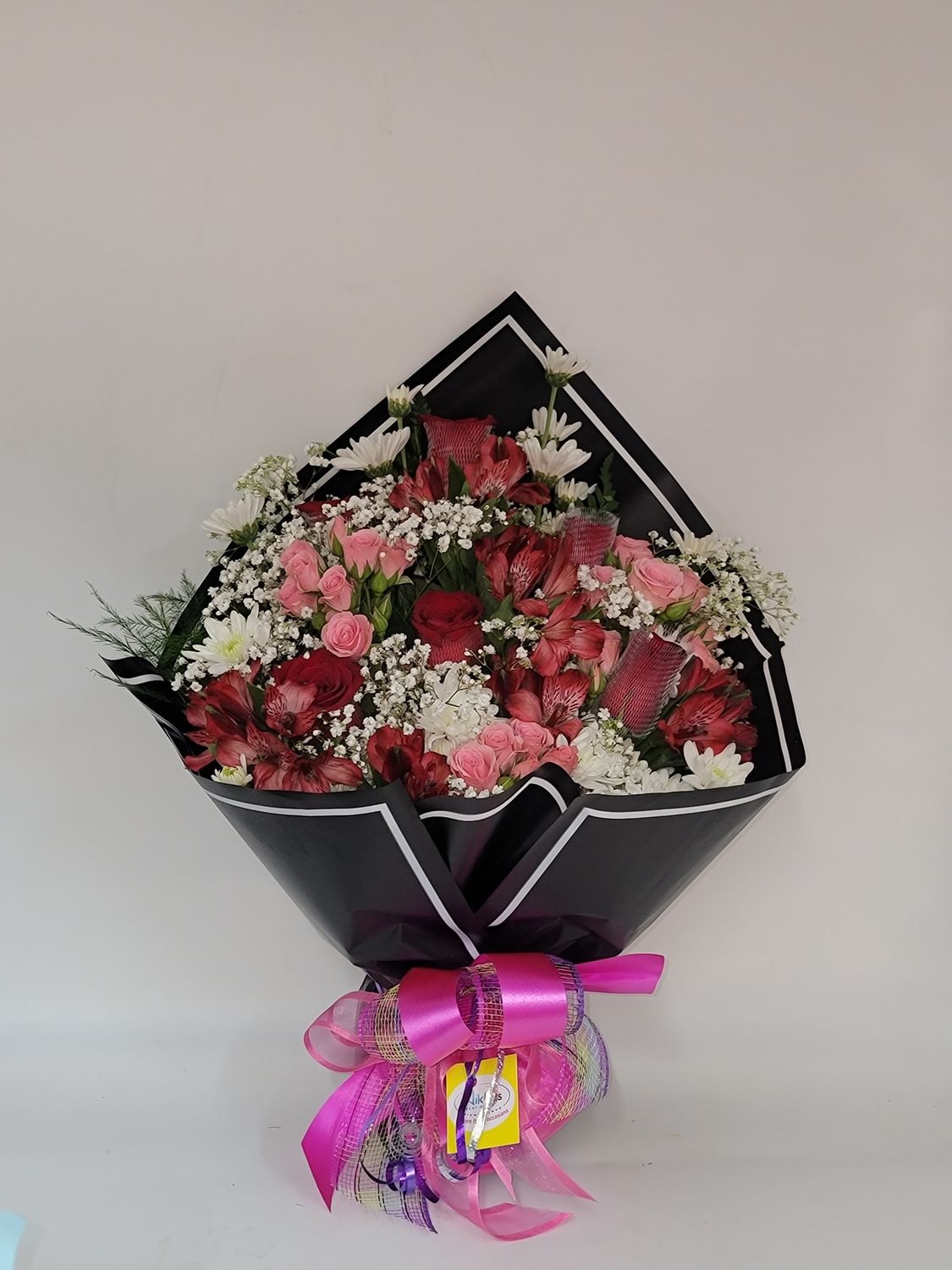 Cut flowers in a black wrap – Nikko's Creations – Flowers For All Occasions