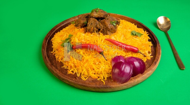 Wooden plate of delicious biryani rice with meat, traditional Arabic ...
