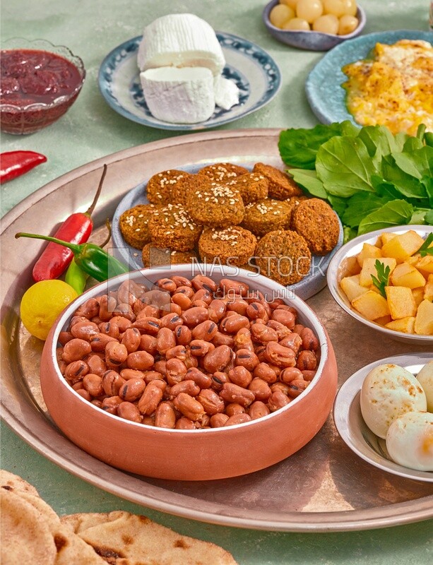 close-up of oriental breakfast, a dish of foul medames, falafel tablets ...