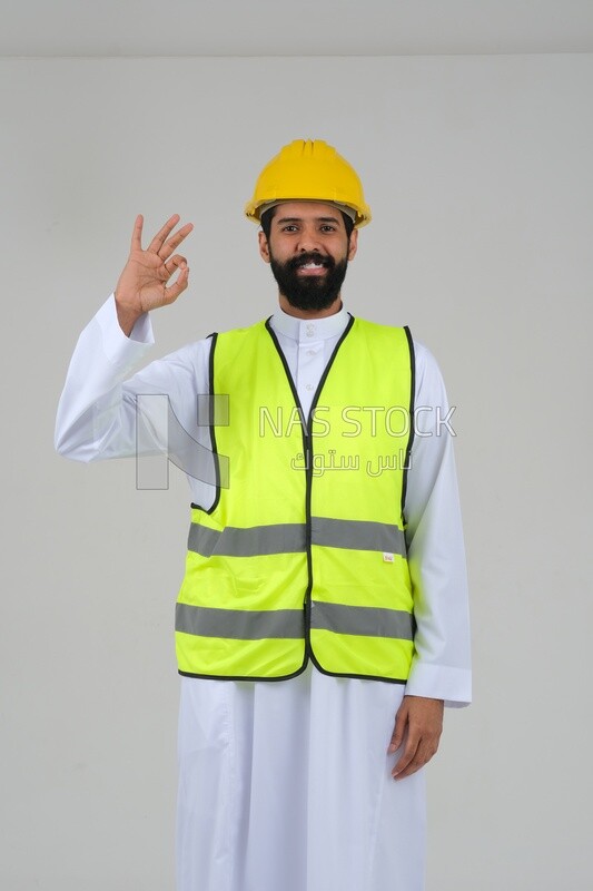 saudi engineer wearing a work hat and safety vest, engineering ...