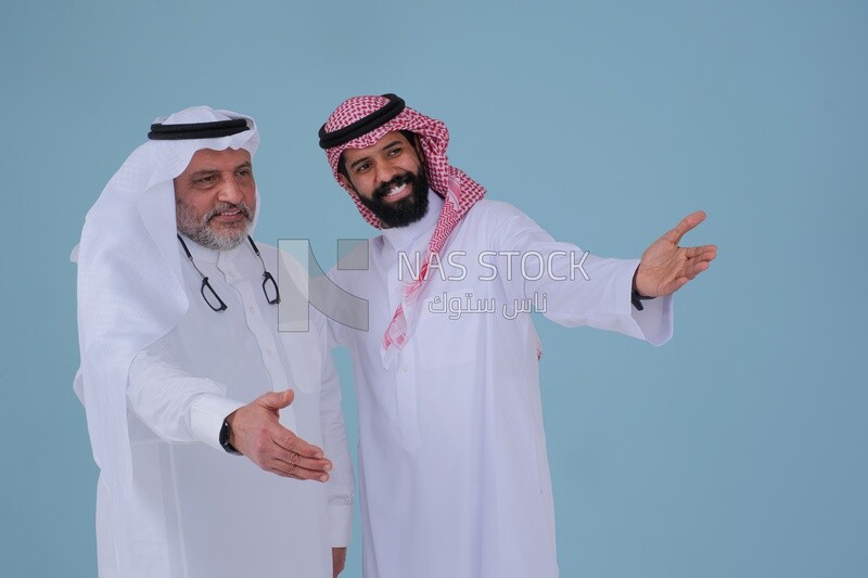 two Saudi men pointing at something, identifying a target, pointing ...