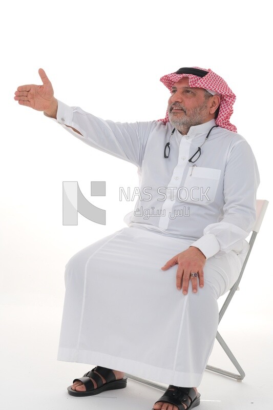 Saudi man in traditional Saudi dress gesturing with handshake gesture ...