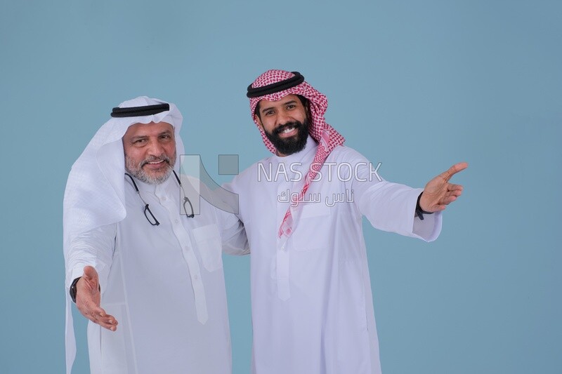 two Saudi men pointing at something, identifying a target, pointing ...