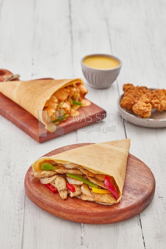 Chicken vegetable crepe with chicken crepe topped with melted cheese