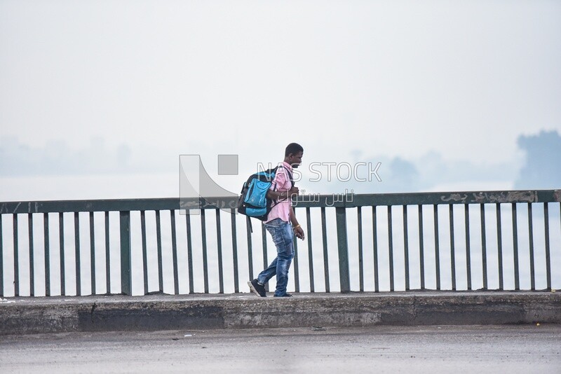African man walking on Abbas Bridge Corniche, Egypt