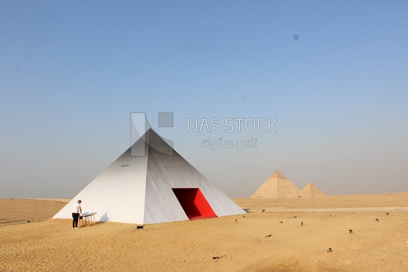 Model pyramid in the historical style next to the pyramids of Giza from ...