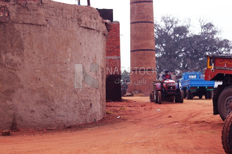 Tractor pulling a load of bricks, brick industry