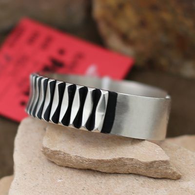 Large silver bracelet by Navajo artist Leander Tahe