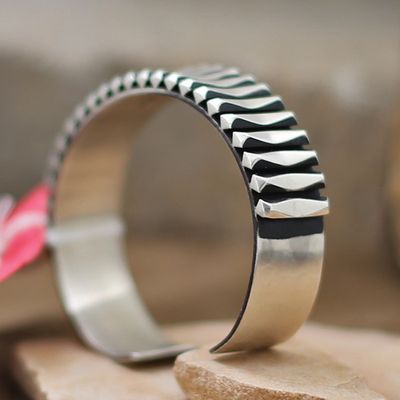 Large silver bracelet by Navajo artist Leander Tahe
